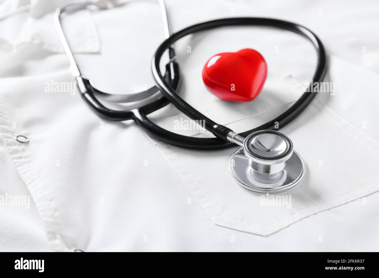 Modern stethoscope with heart on doctor's uniform Stock Photo - Alamy
