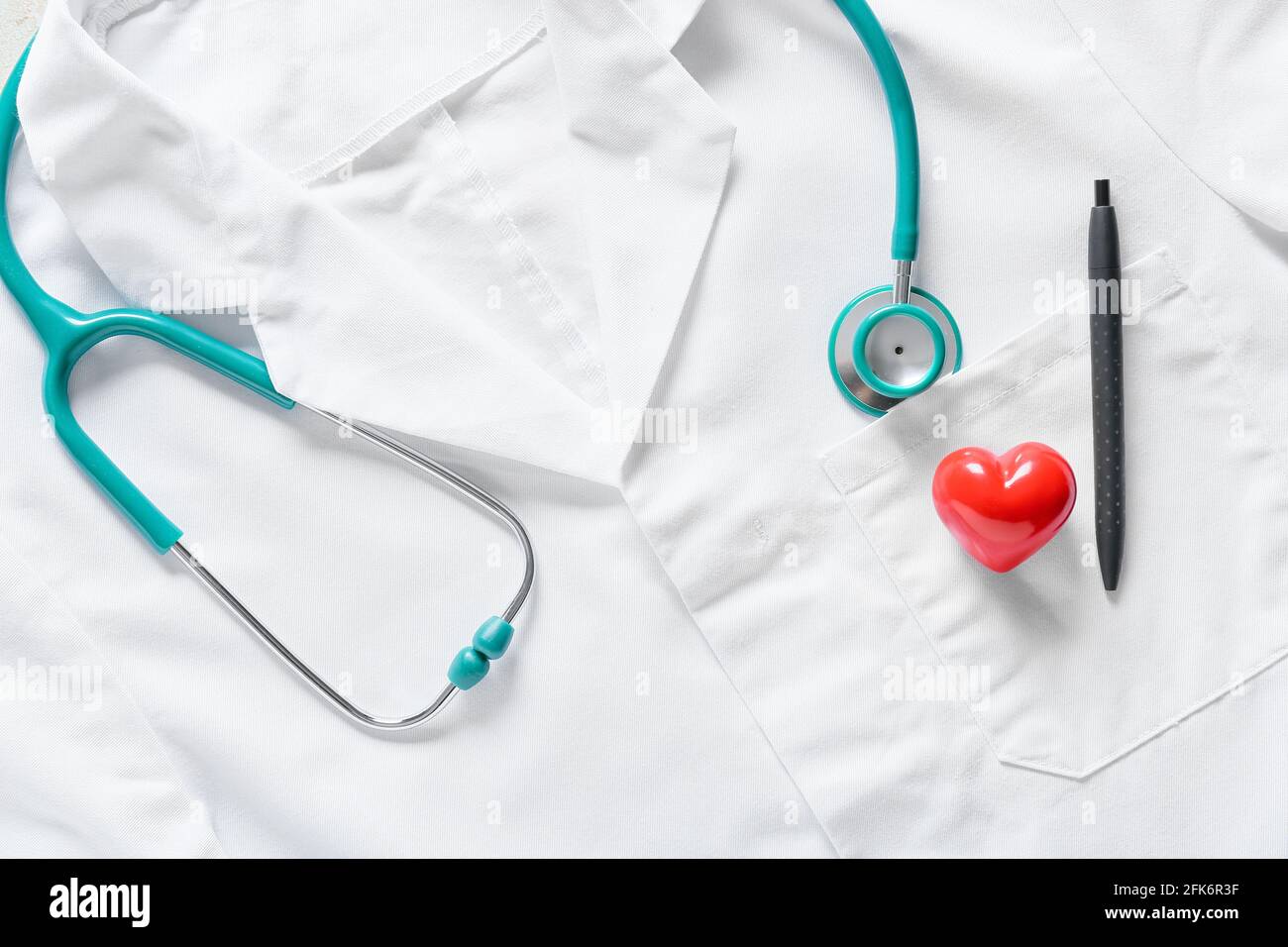 Modern stethoscope with heart and pen on doctor's uniform Stock Photo ...