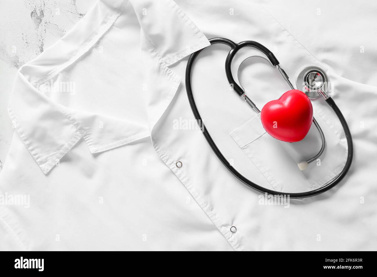Modern stethoscope with heart on doctor's uniform Stock Photo - Alamy