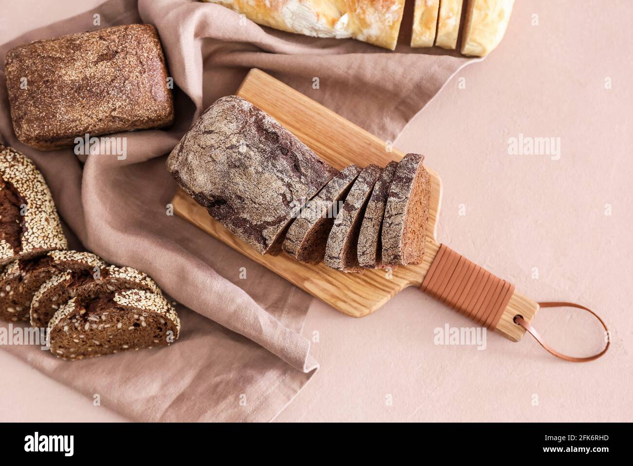 Board with fresh cut bread on color background Stock Photo - Alamy