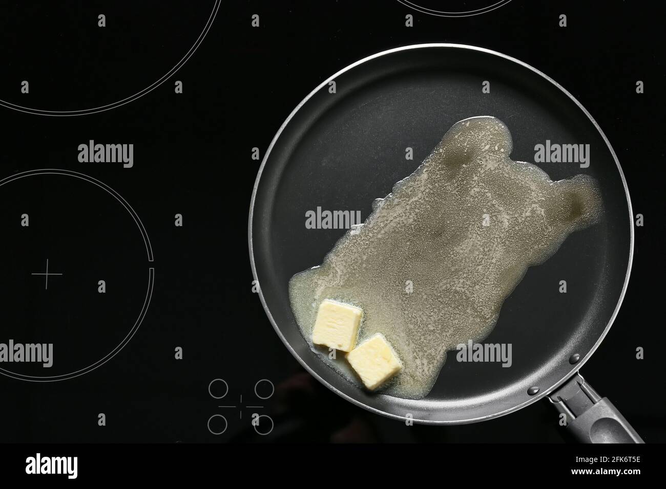 Frying pan with melted butter on stove Stock Photo - Alamy