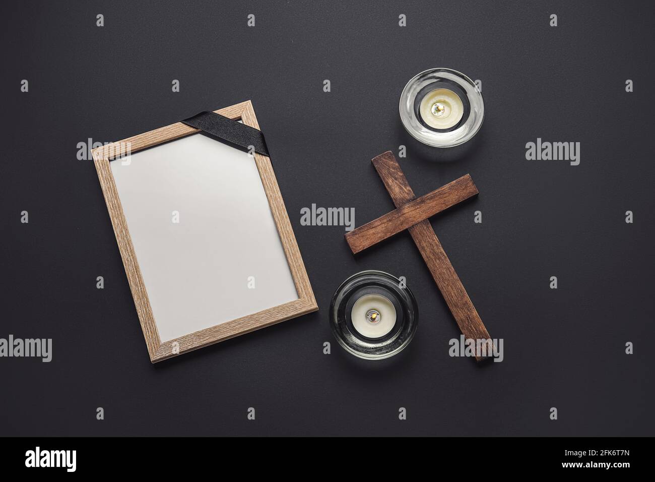 Wooden cross, photo frame and candles on dark background Stock Photo ...