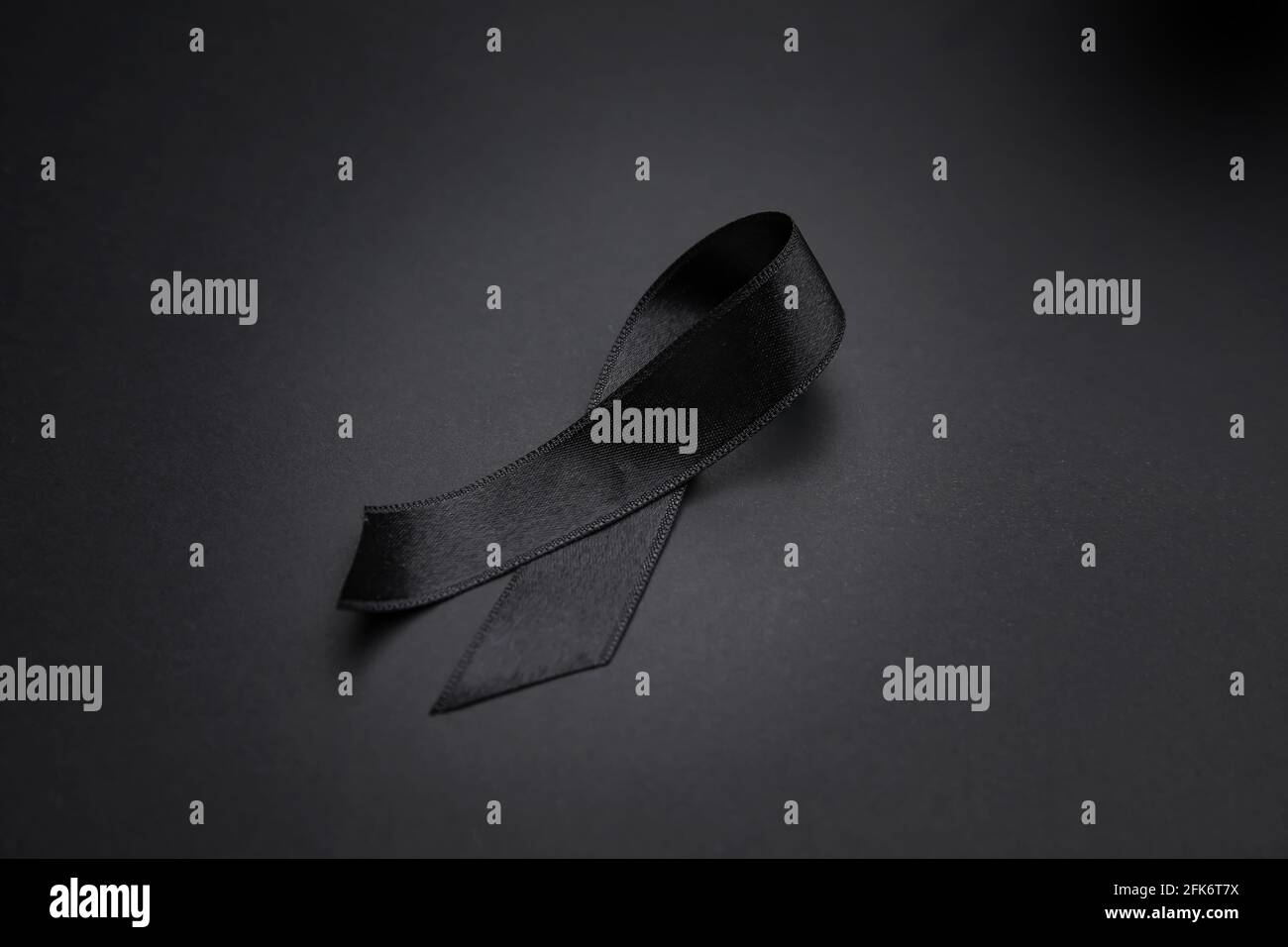 Black funeral ribbon on dark background Stock Photo - Alamy
