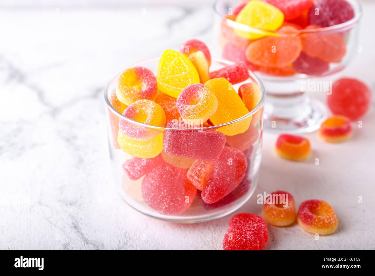 Bowls with jelly candies on light background Stock Photo - Alamy