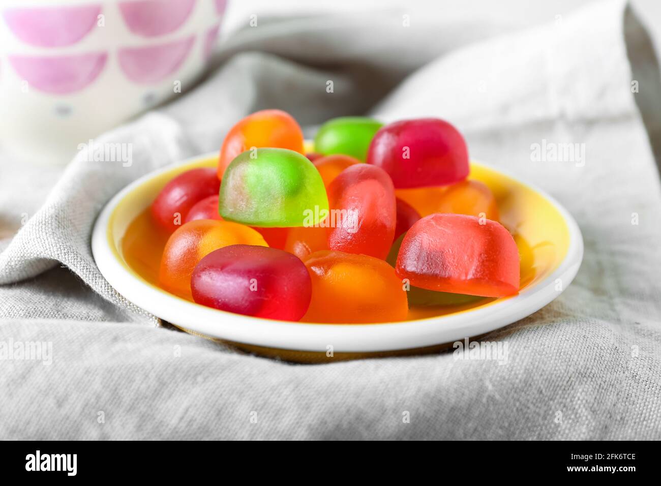 Plate with sweet jelly candies on light background Stock Photo - Alamy