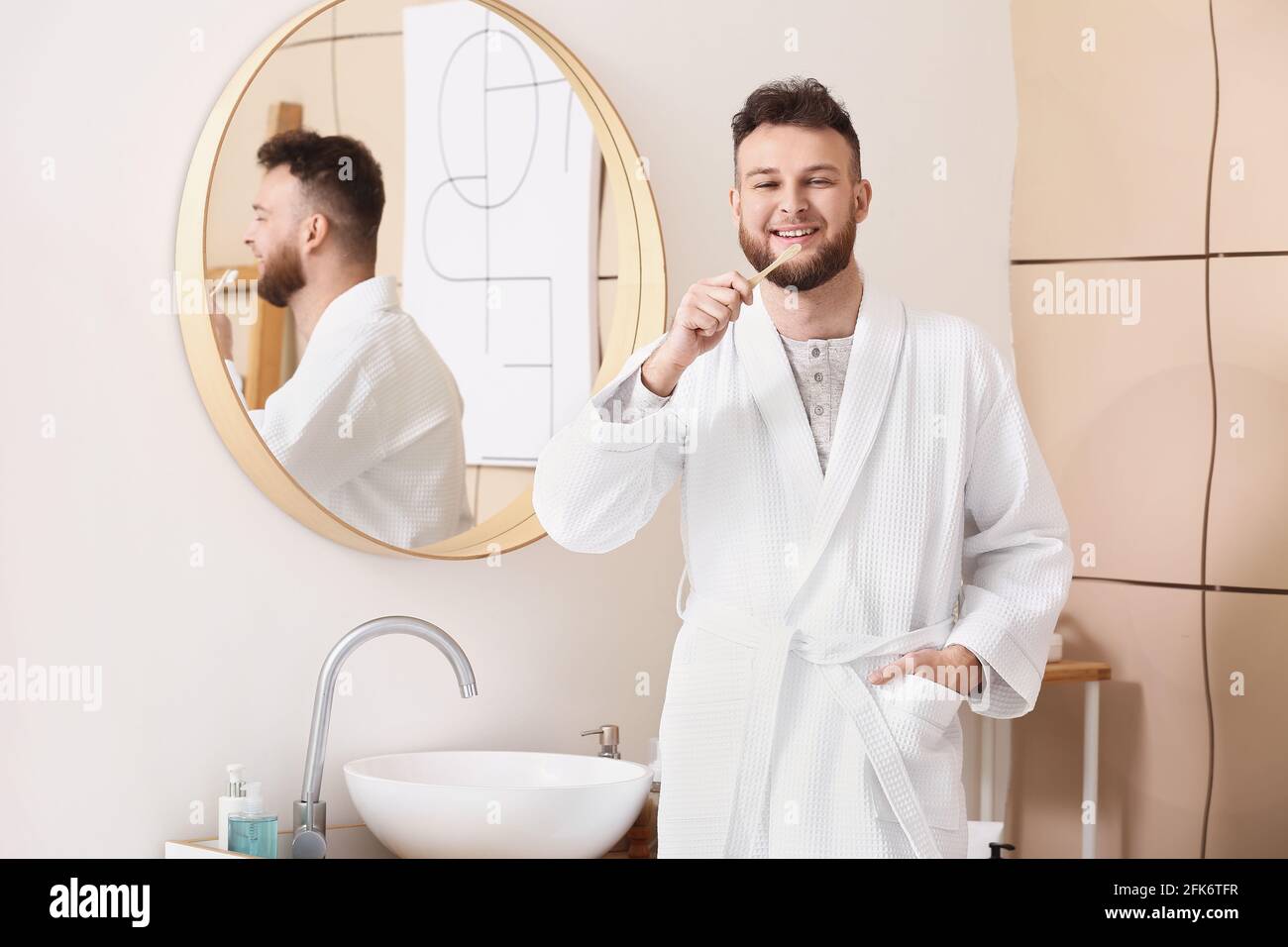 Handsome man brushing teeth in bathroom Stock Photo - Alamy