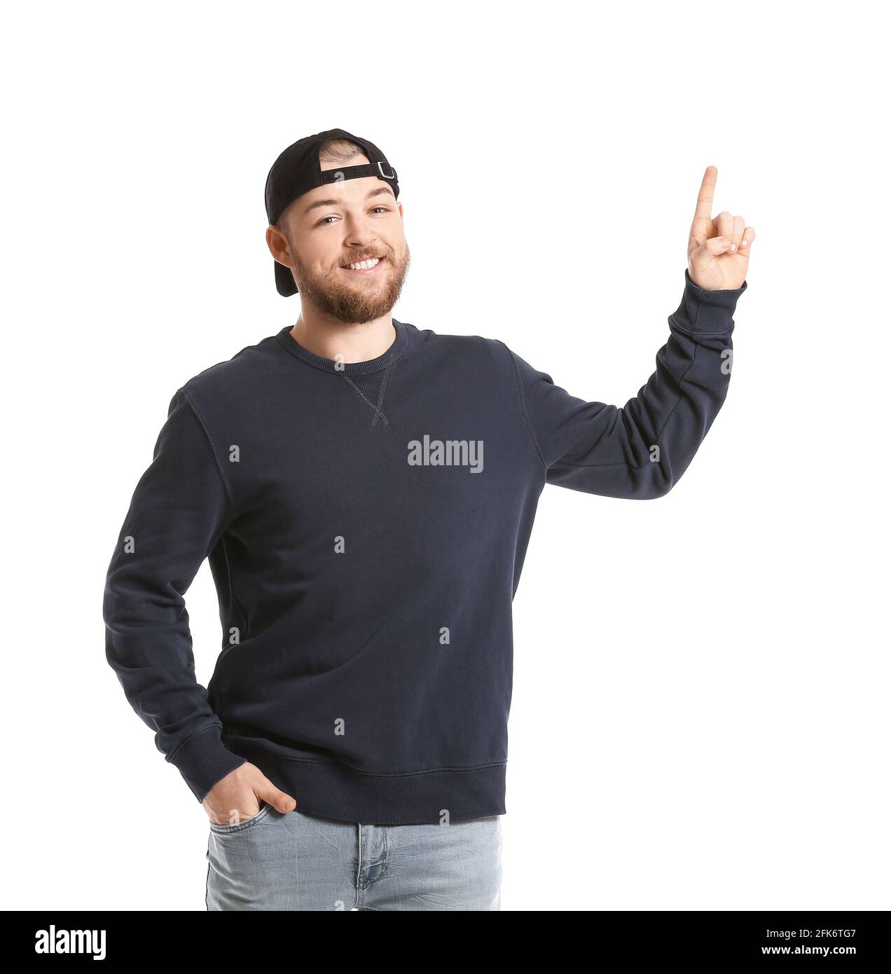 Handsome man pointing at something on white background Stock Photo - Alamy