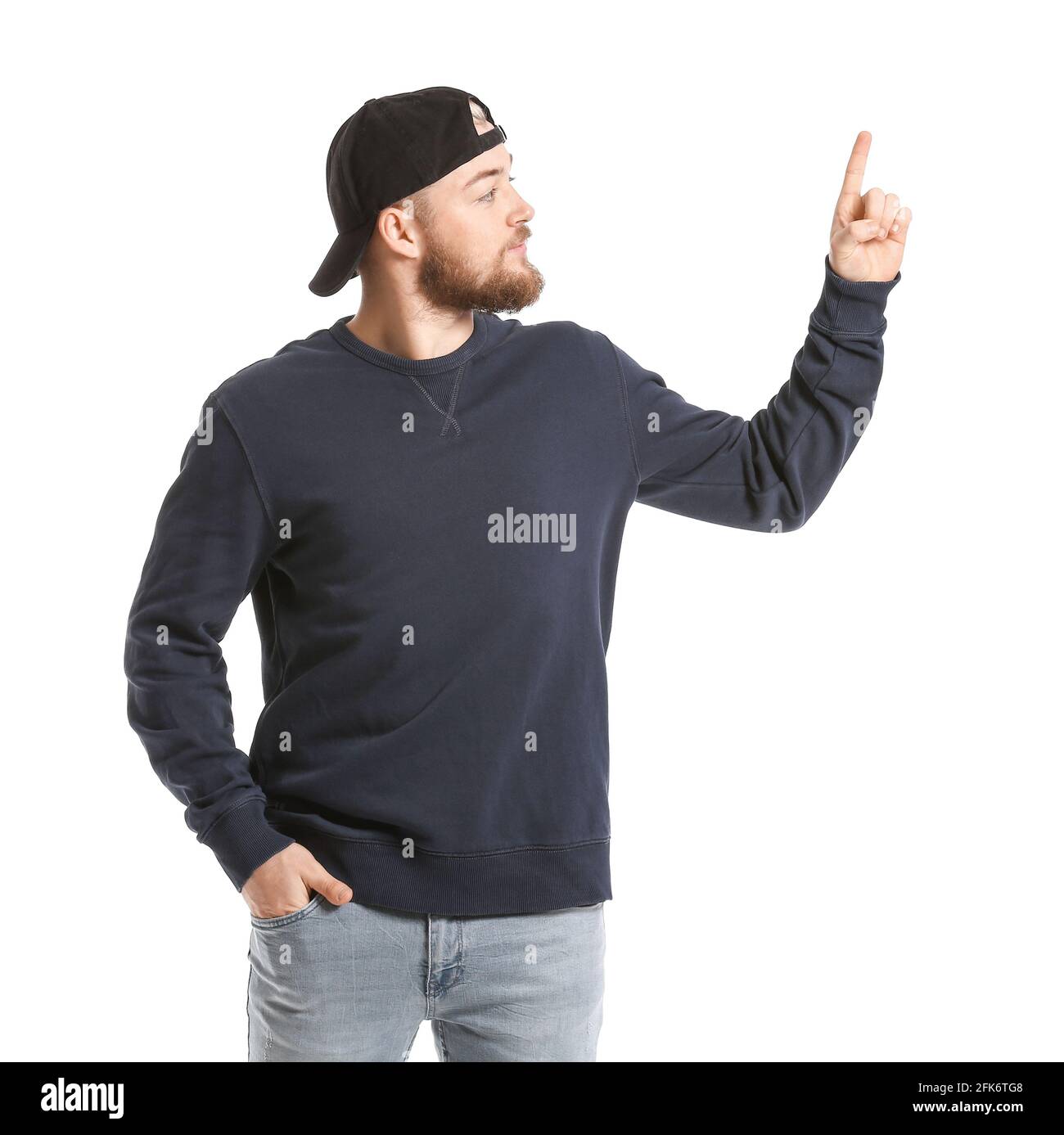 Handsome man pointing at something on white background Stock Photo - Alamy