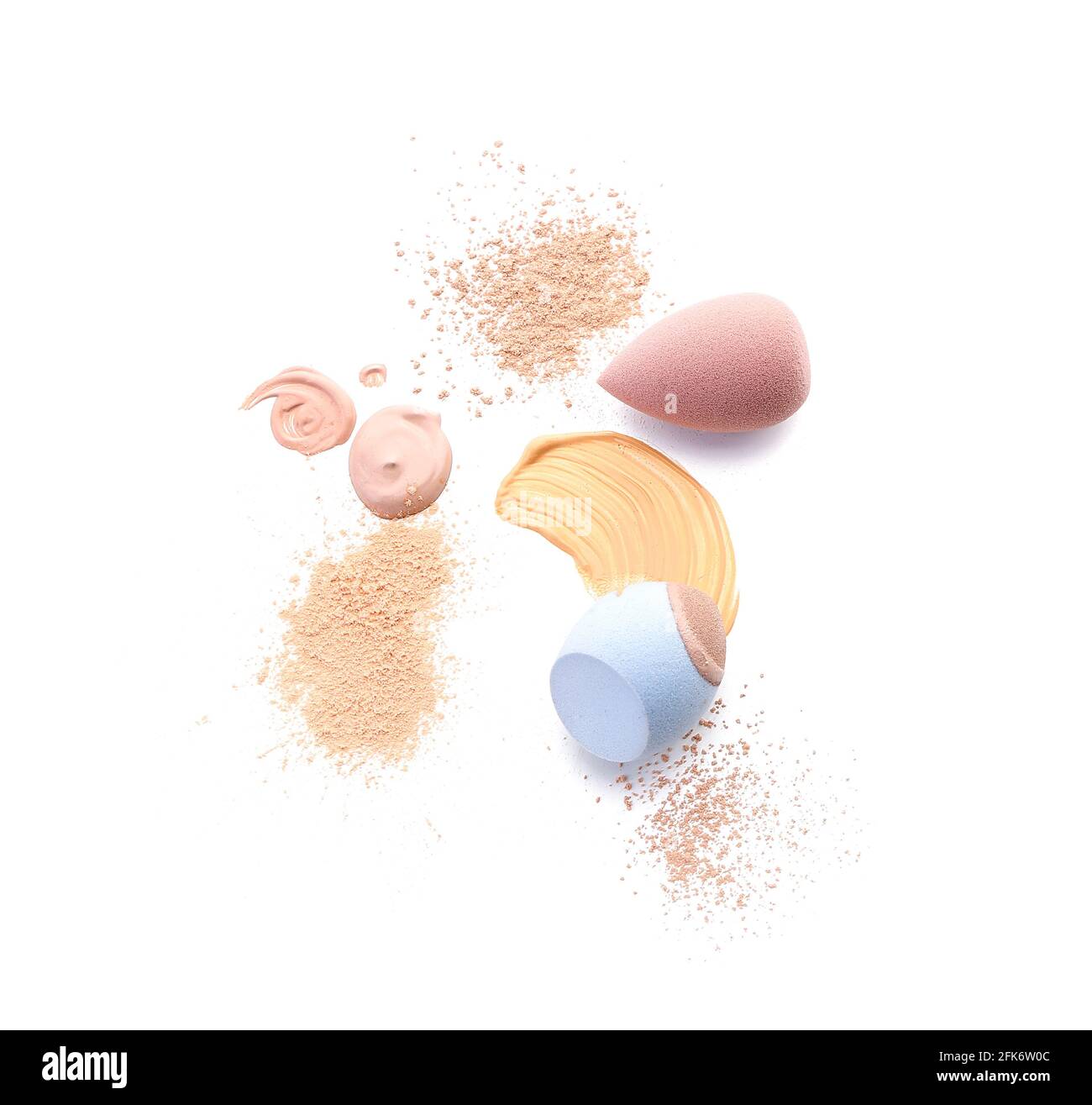 Different makeup sponges, foundation and face powder samples on white ...