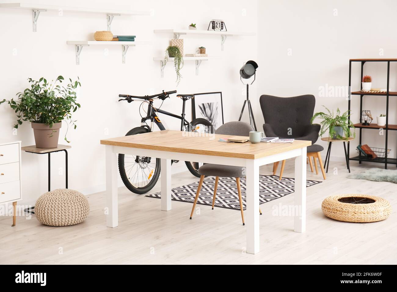 Modern bicycle in interior of living room Stock Photo - Alamy