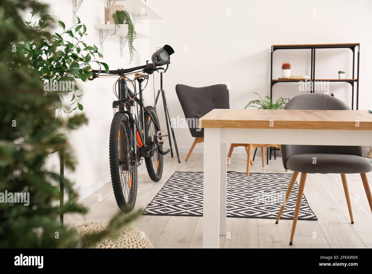 Modern bicycle in interior of living room Stock Photo - Alamy