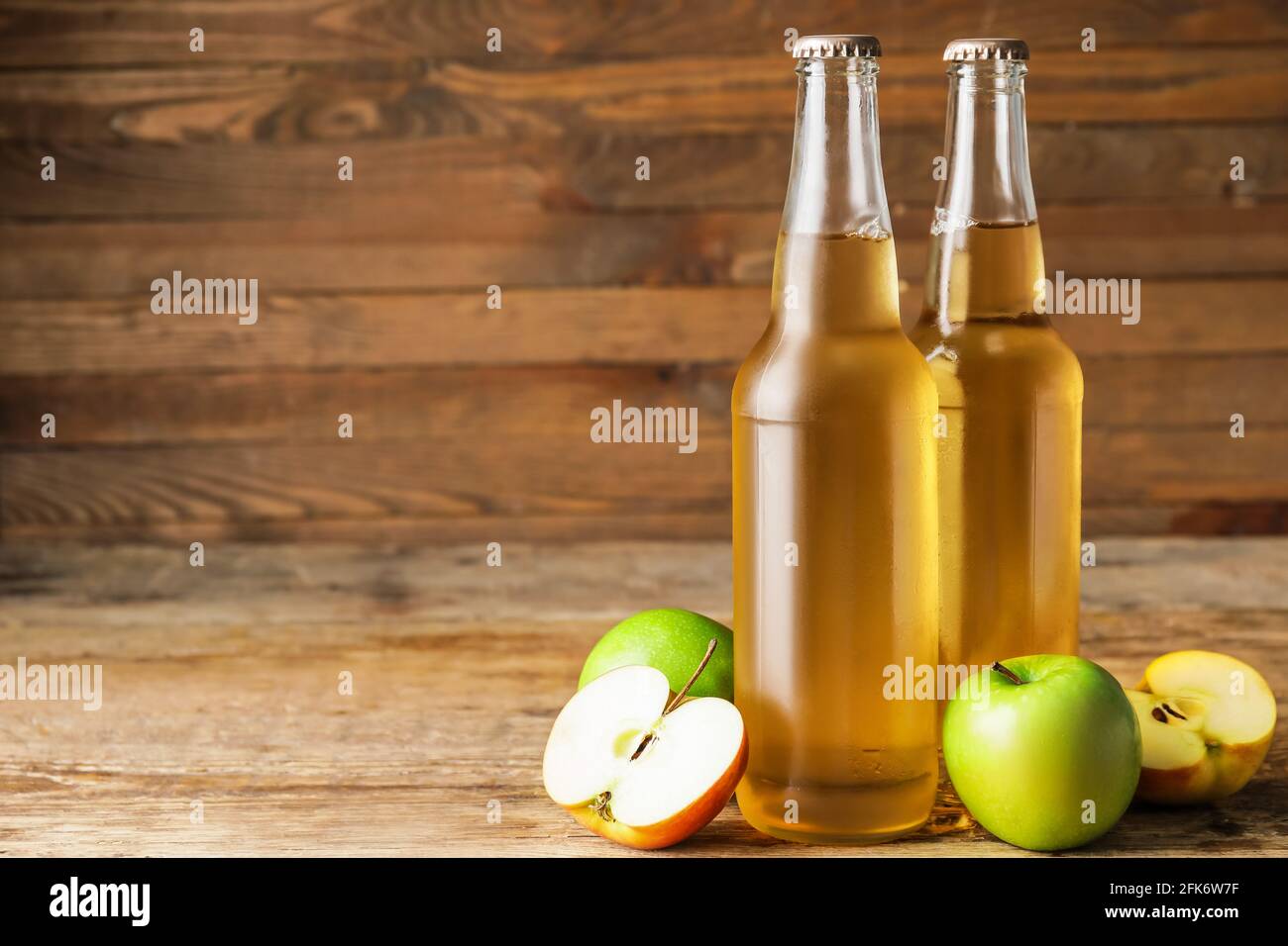 Bottles of apple cider on wooden background Stock Photo - Alamy
