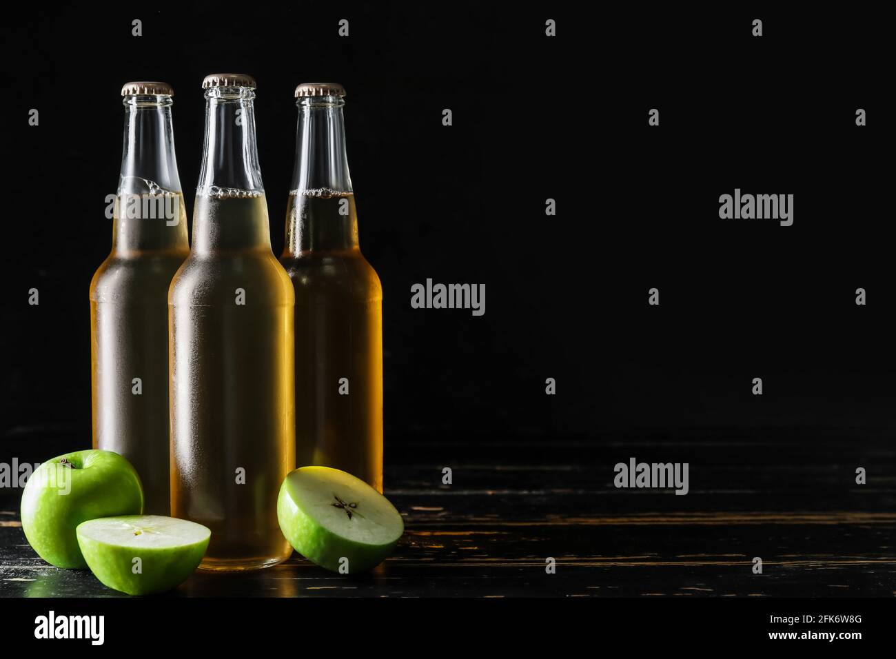 Bottles of apple cider on dark background Stock Photo - Alamy