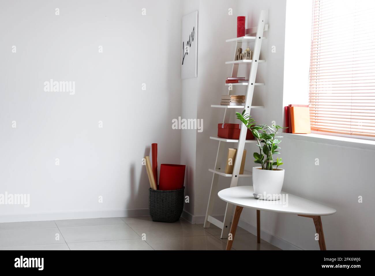 Interior of modern room with shelf unit and table Stock Photo - Alamy