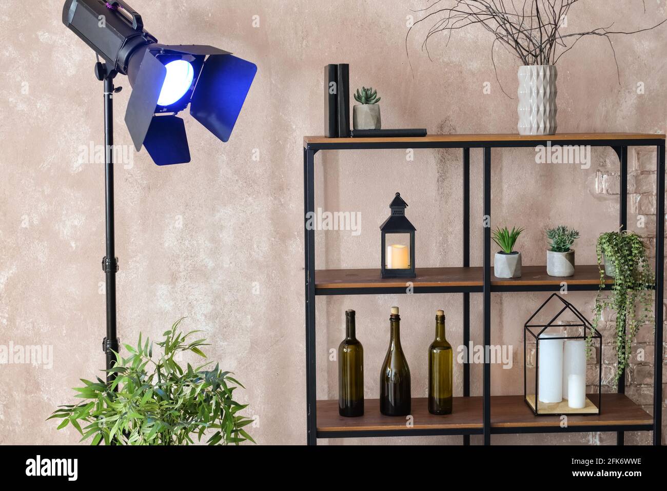 Modern shelf unit with glowing lamp near light wall Stock Photo - Alamy