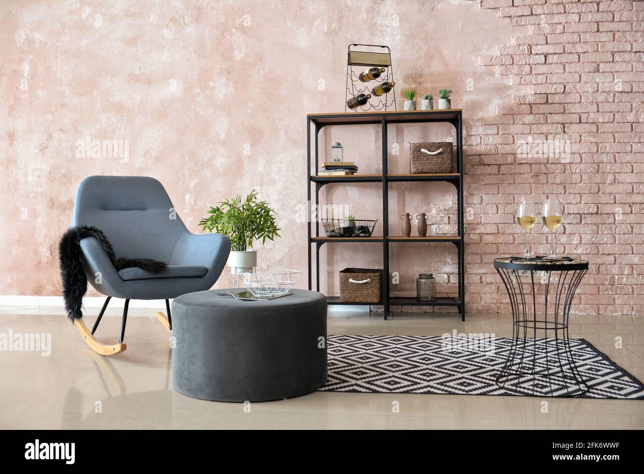 Interior of modern room with armchair and shelf unit Stock Photo - Alamy