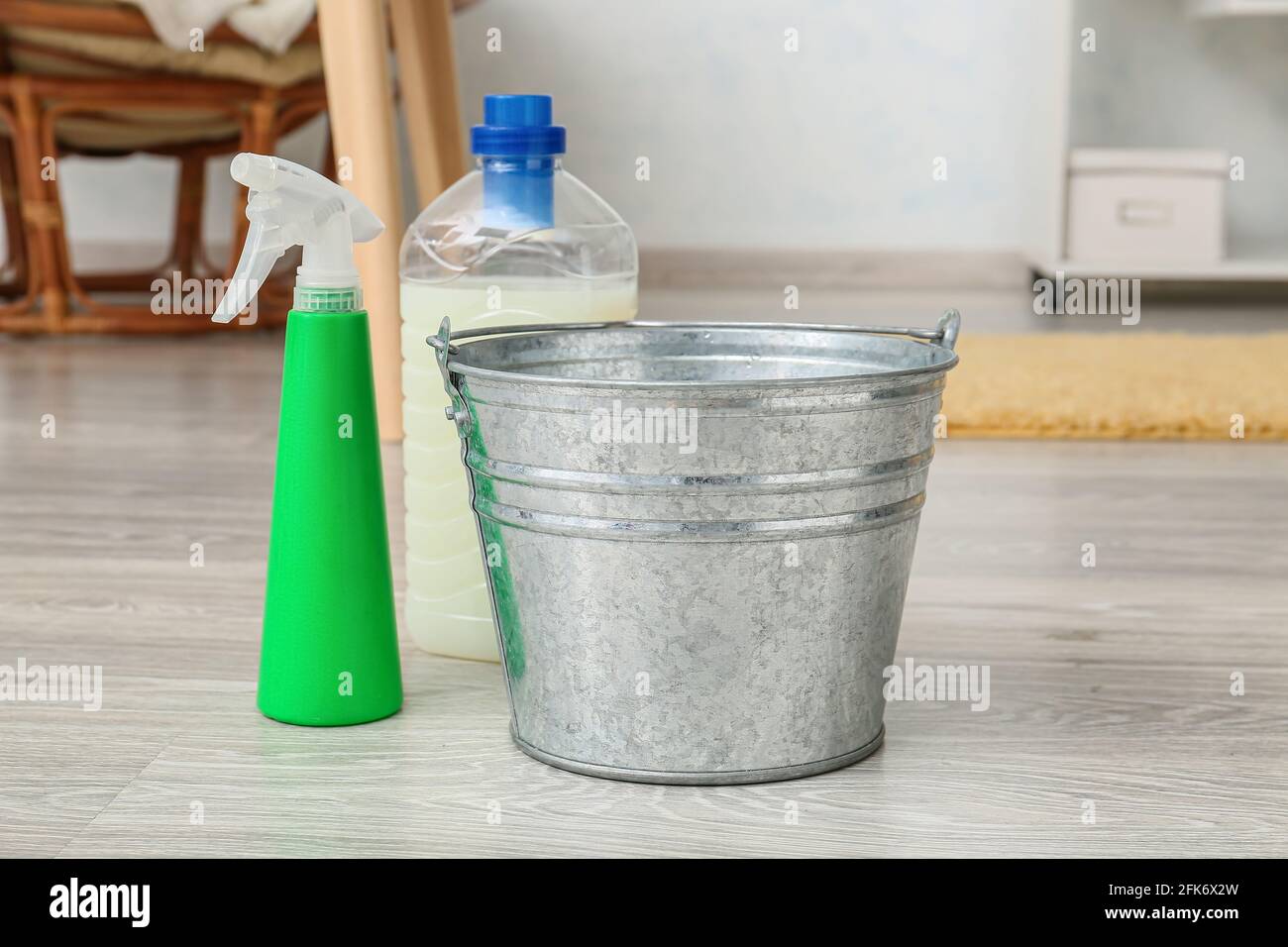 Metal bucket with cleaning supplies in room Stock Photo - Alamy