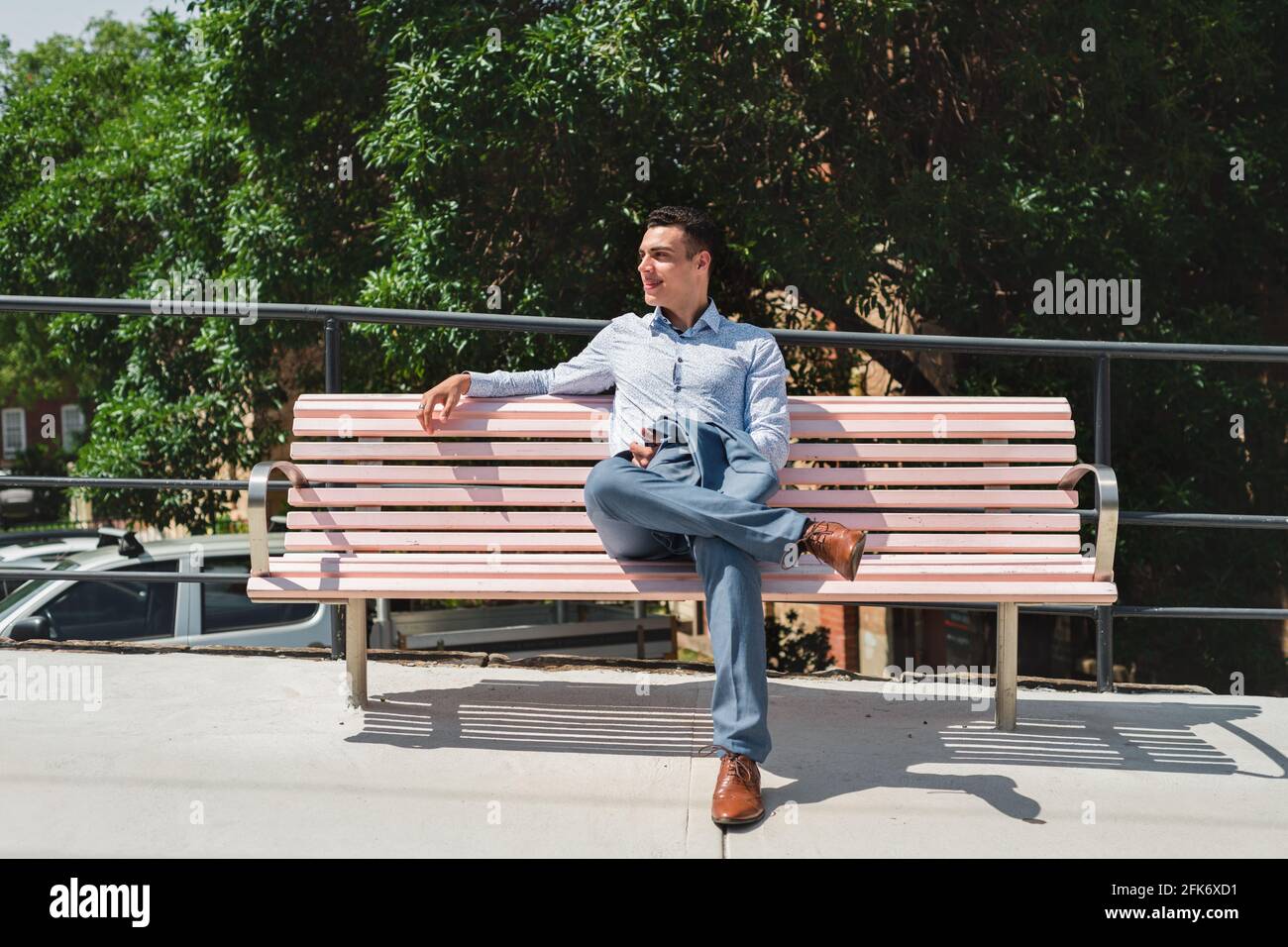 man sitting on pink bench Stock Photo - Alamy