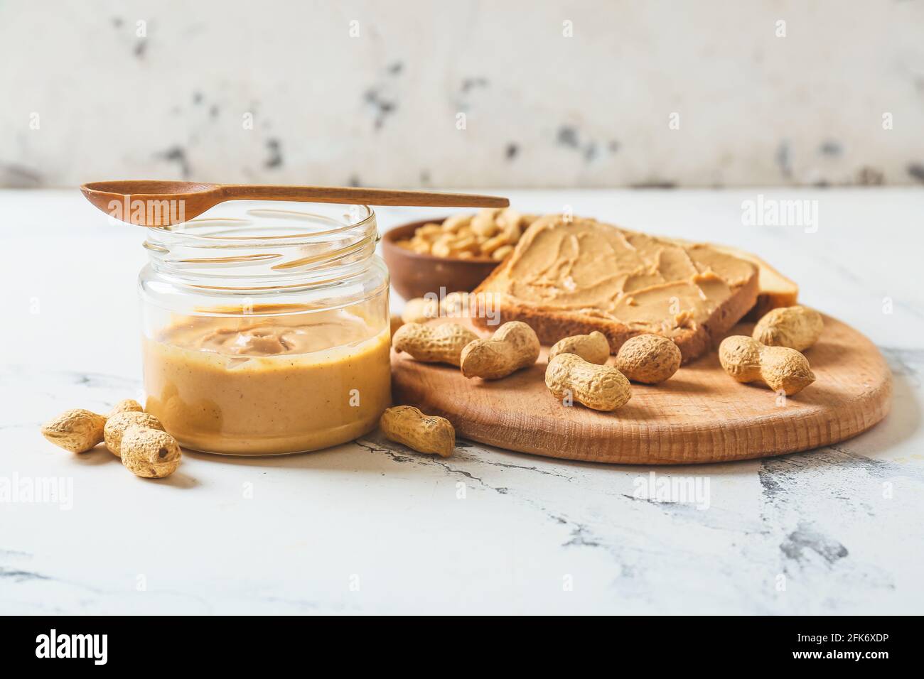Jar and toast with tasty peanut butter on light background Stock Photo ...