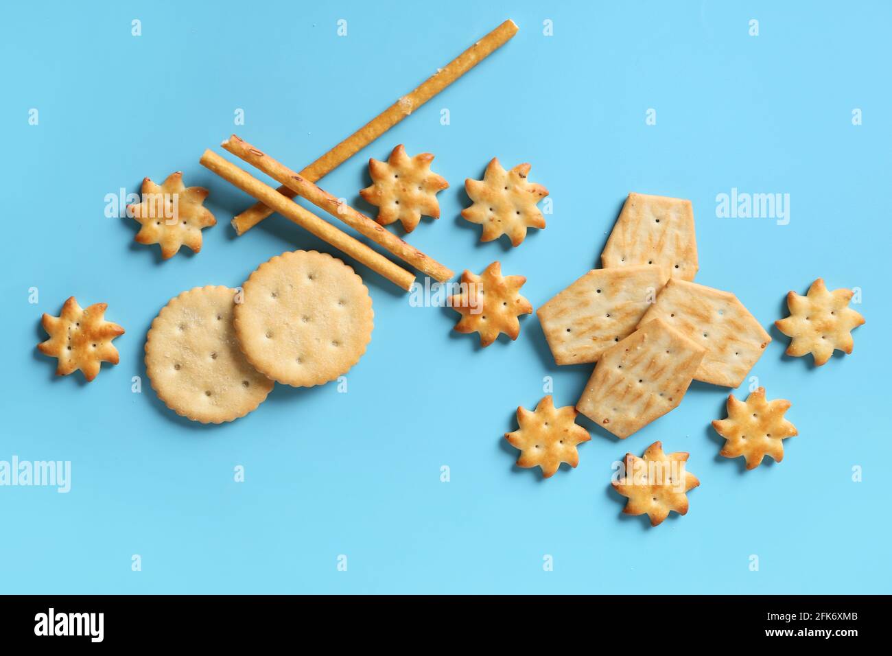 Tasty different crackers on color background Stock Photo - Alamy