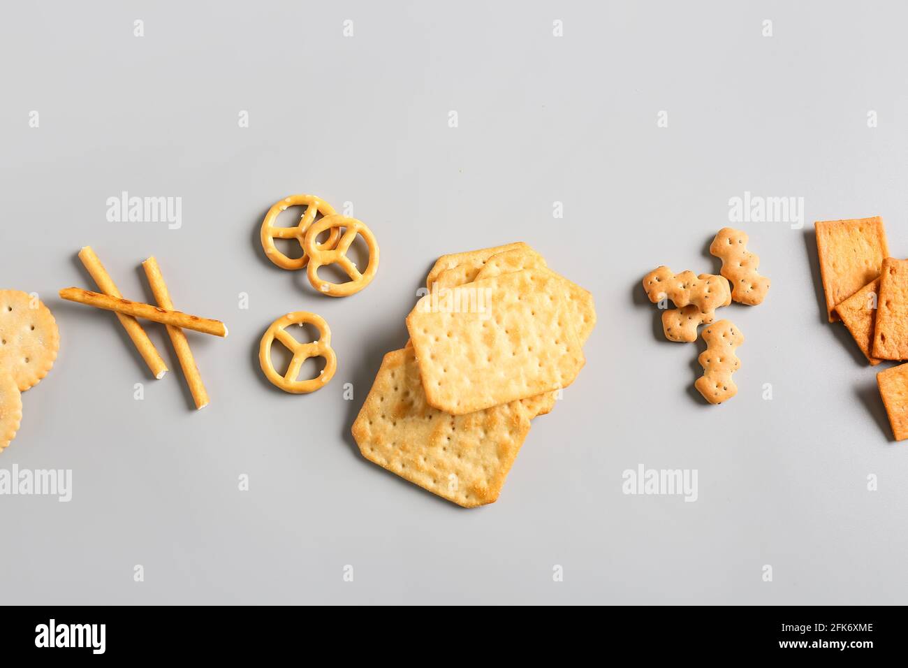 Tasty different crackers on light background Stock Photo - Alamy