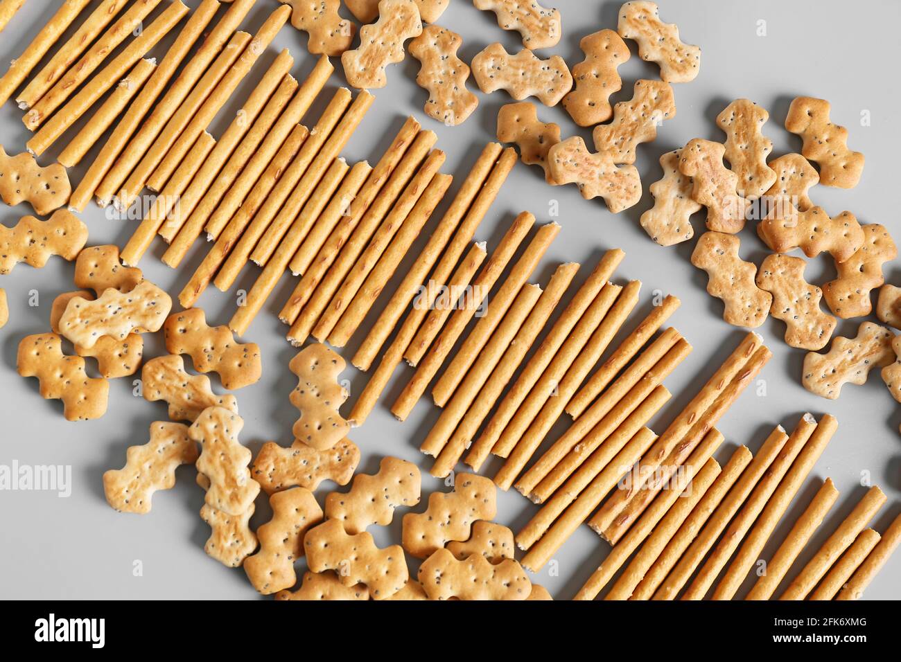 Tasty different crackers on light background Stock Photo - Alamy