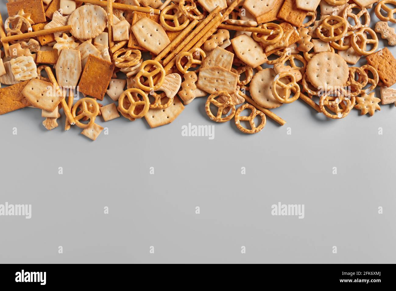 Tasty different crackers on light background Stock Photo - Alamy