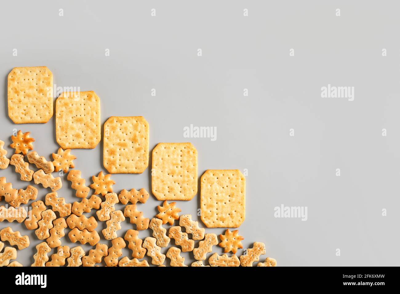 Tasty different crackers on light background Stock Photo - Alamy