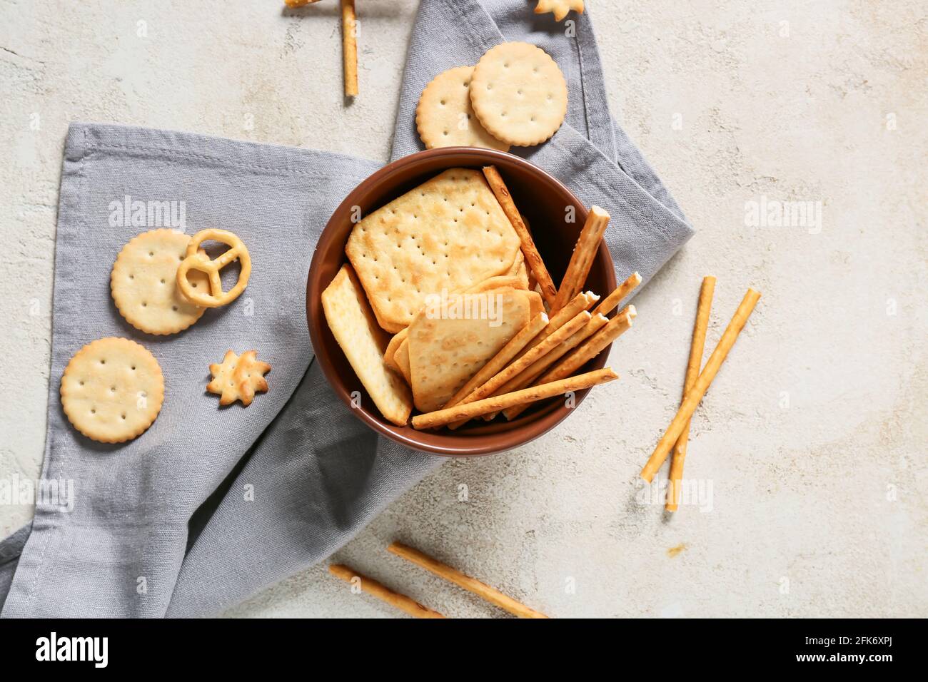 Bowl with tasty different crackers on light background Stock Photo - Alamy