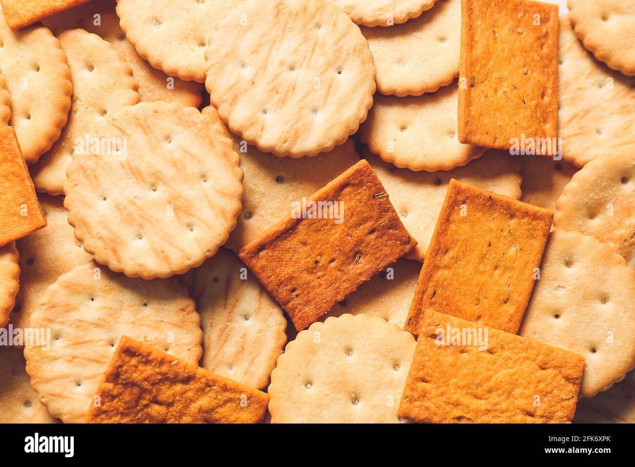 Tasty different crackers as background Stock Photo - Alamy