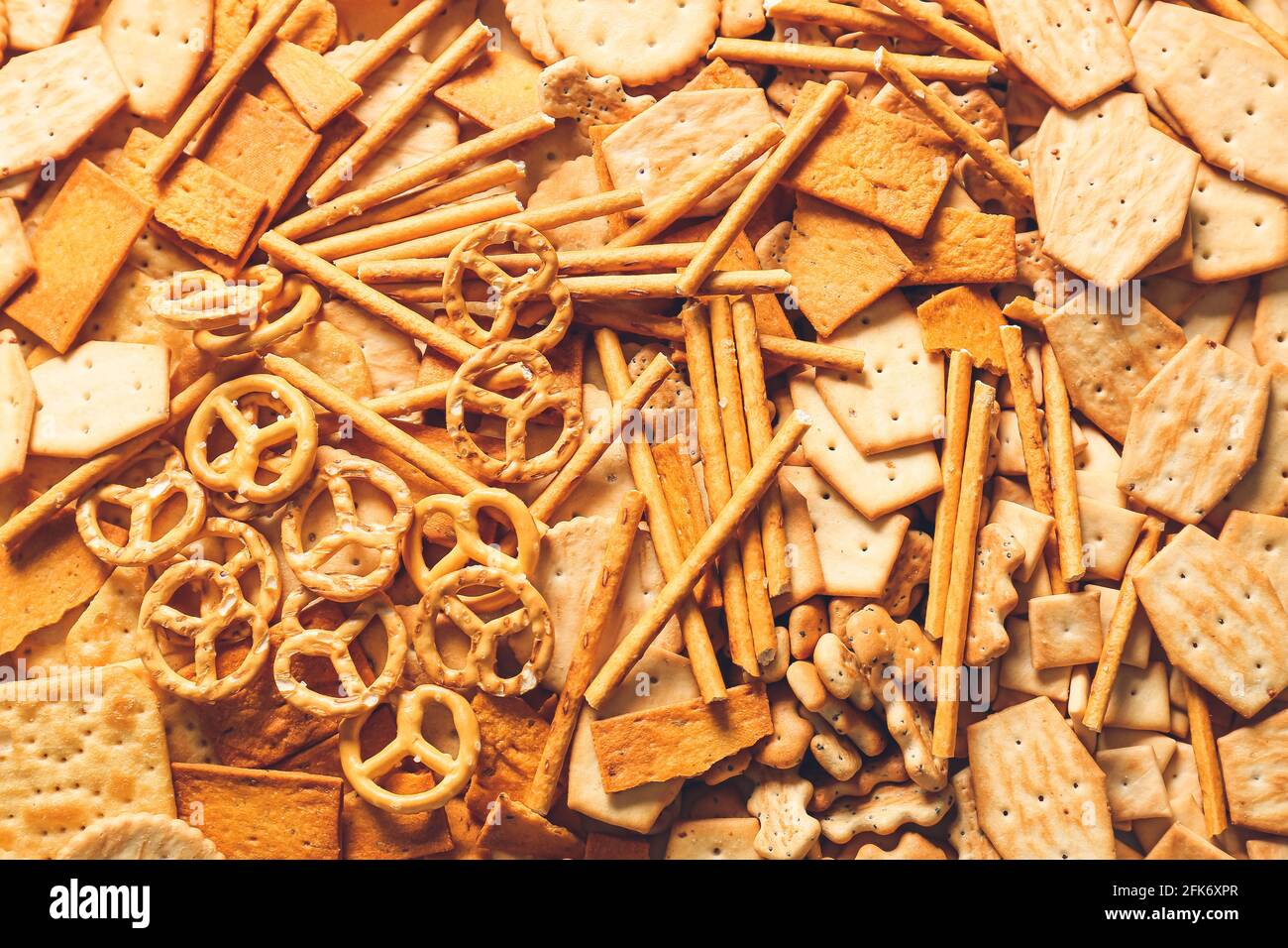 Tasty different crackers as background Stock Photo - Alamy