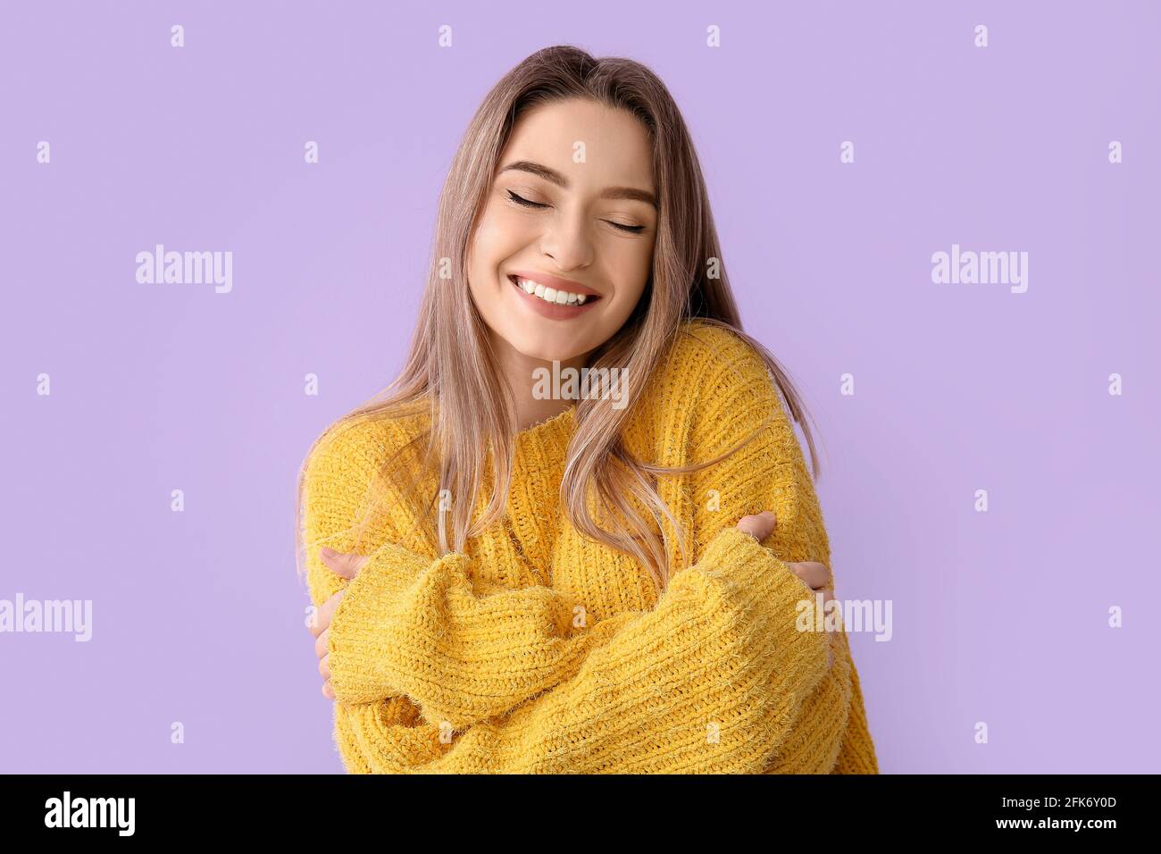 Young woman hugging herself hi-res stock photography and images - Alamy