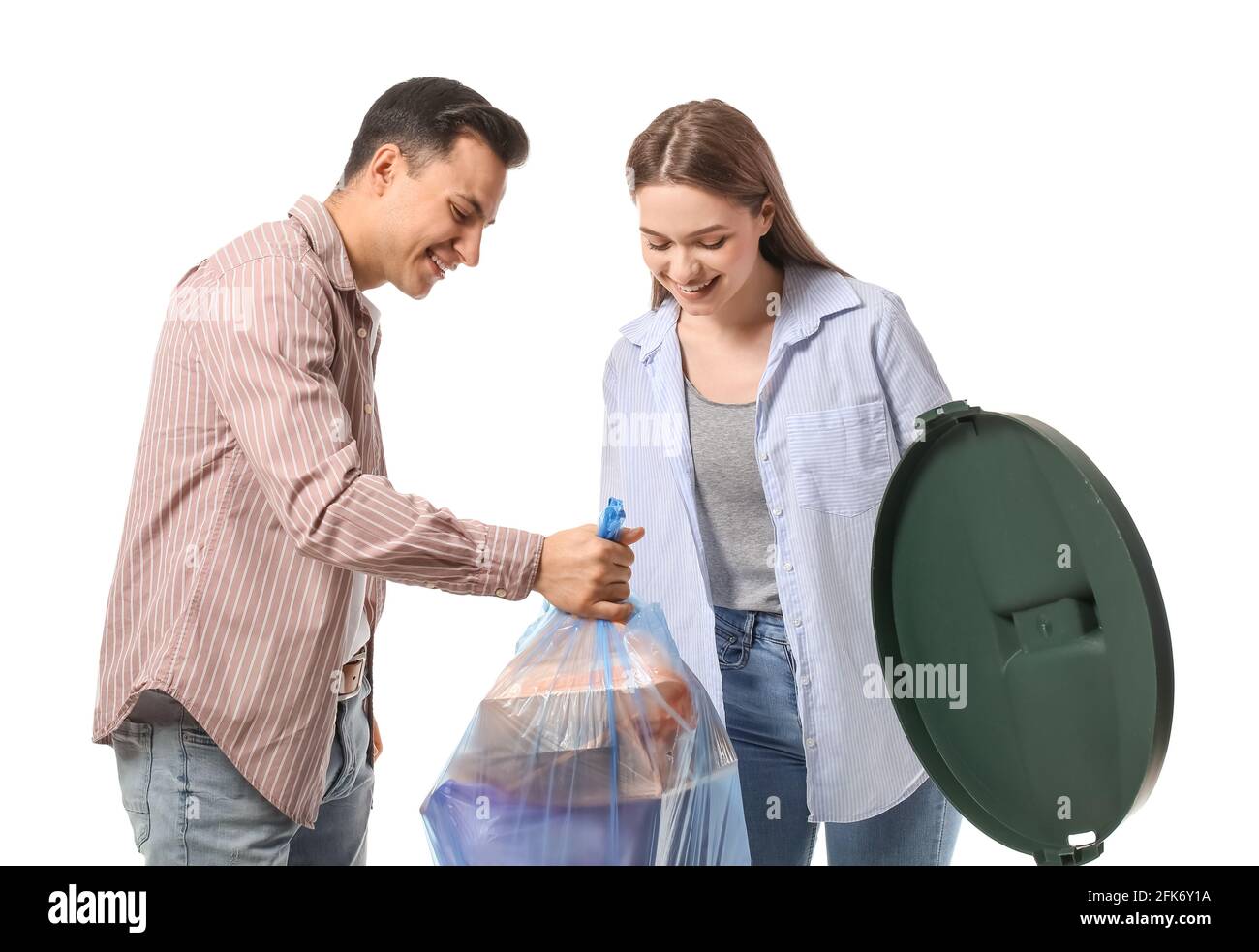 Young couple throwing garbage in trash bin on white background Stock ...