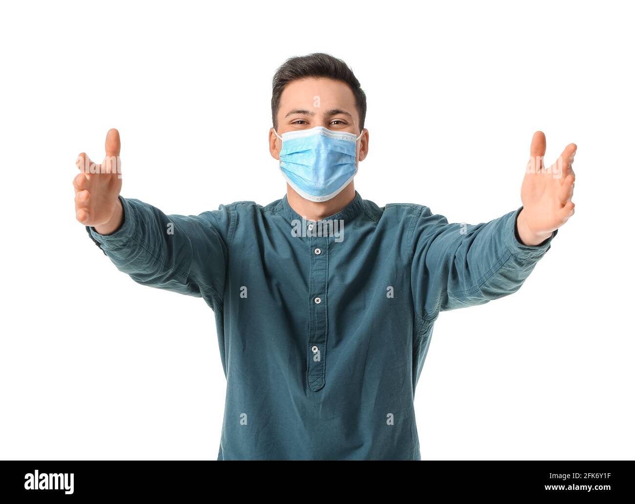 Young man in medical mask opening arms for hug on white background ...