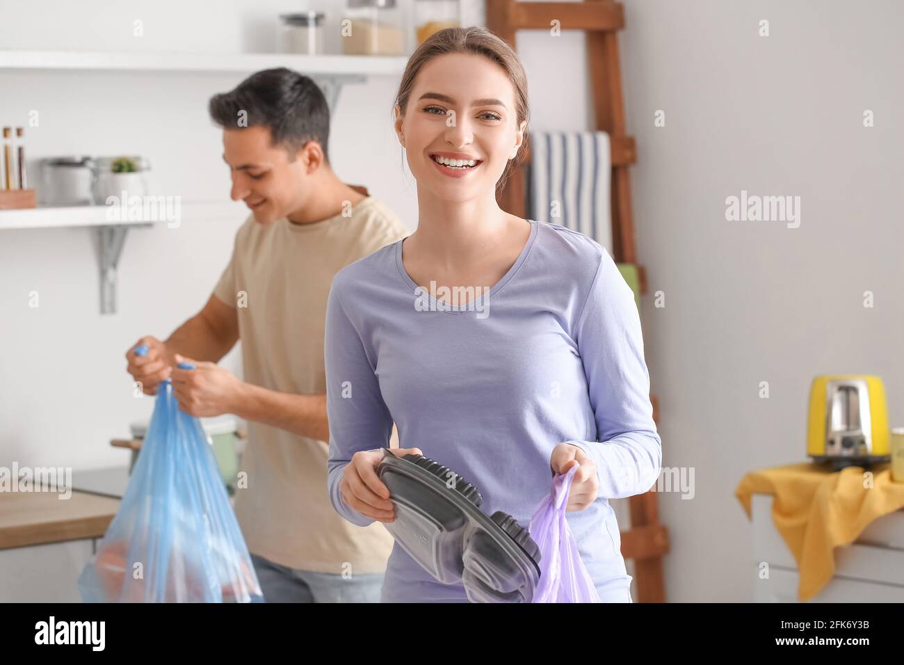 Young couple with garbage at home Stock Photo - Alamy