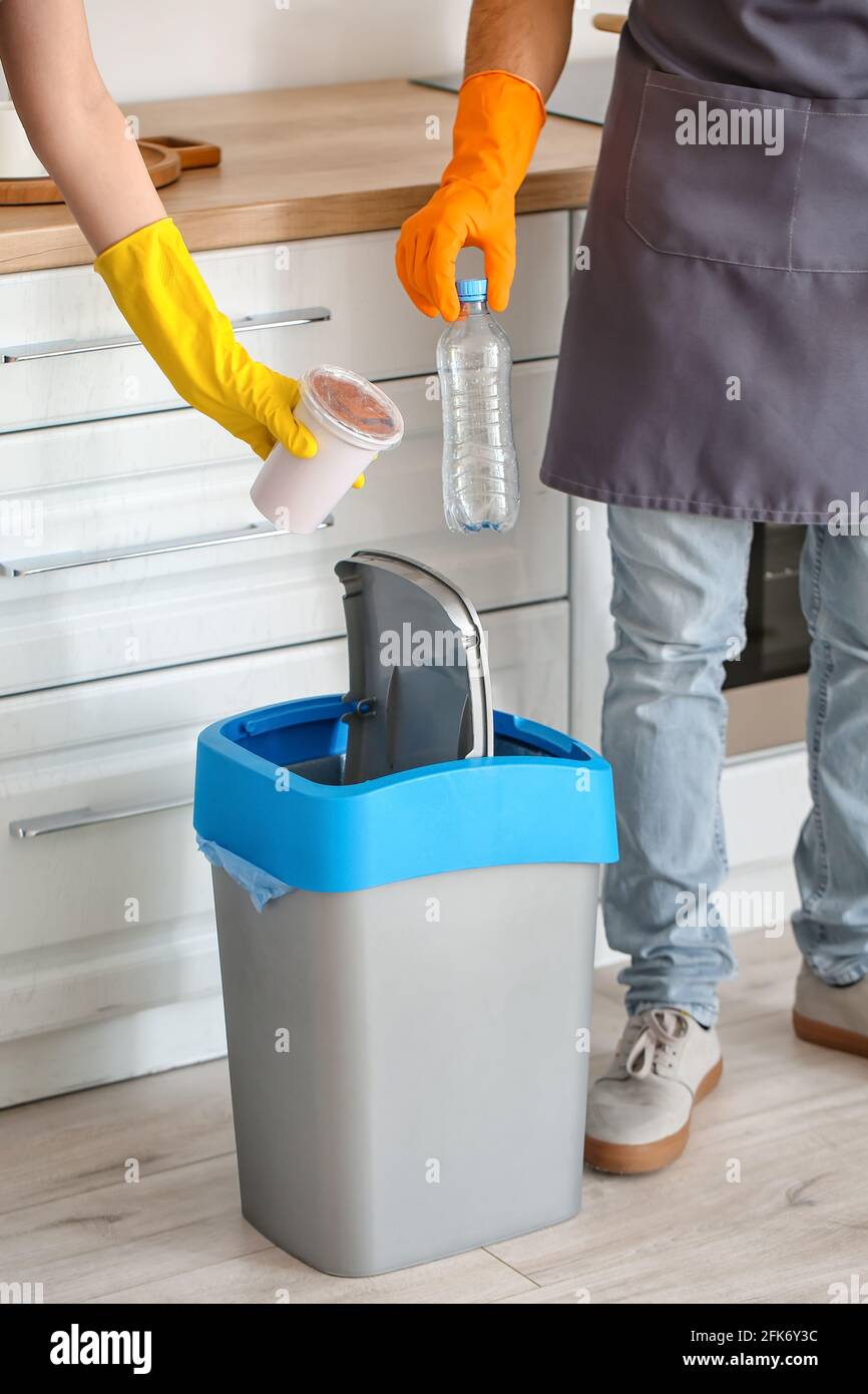 Janitors throwing garbage in bin at home Stock Photo - Alamy