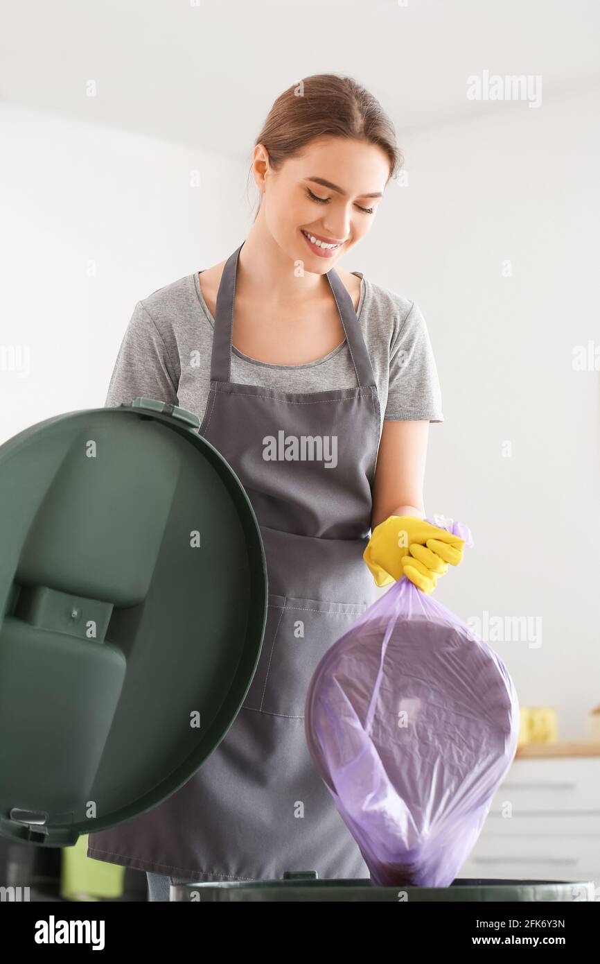Janitor throwing garbage in bin at home Stock Photo - Alamy