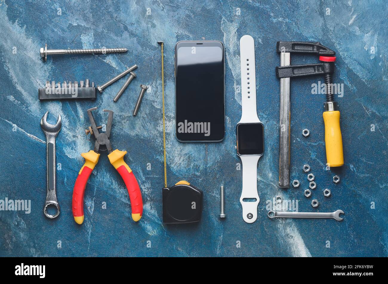 Set of tools with mobile phone and smart watch on color background ...
