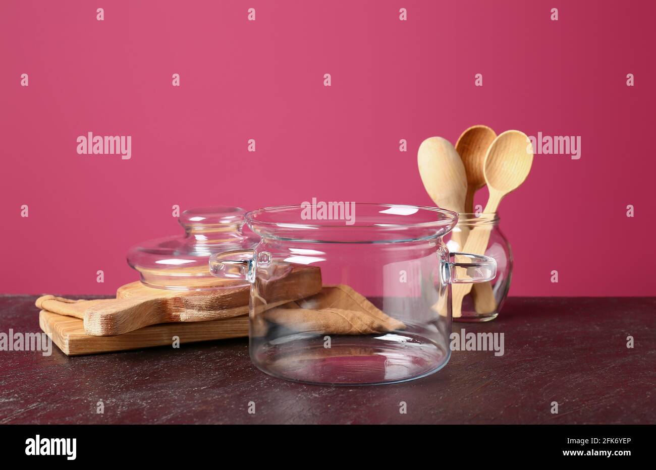 Stylish cooking pot and utensils on table Stock Photo - Alamy