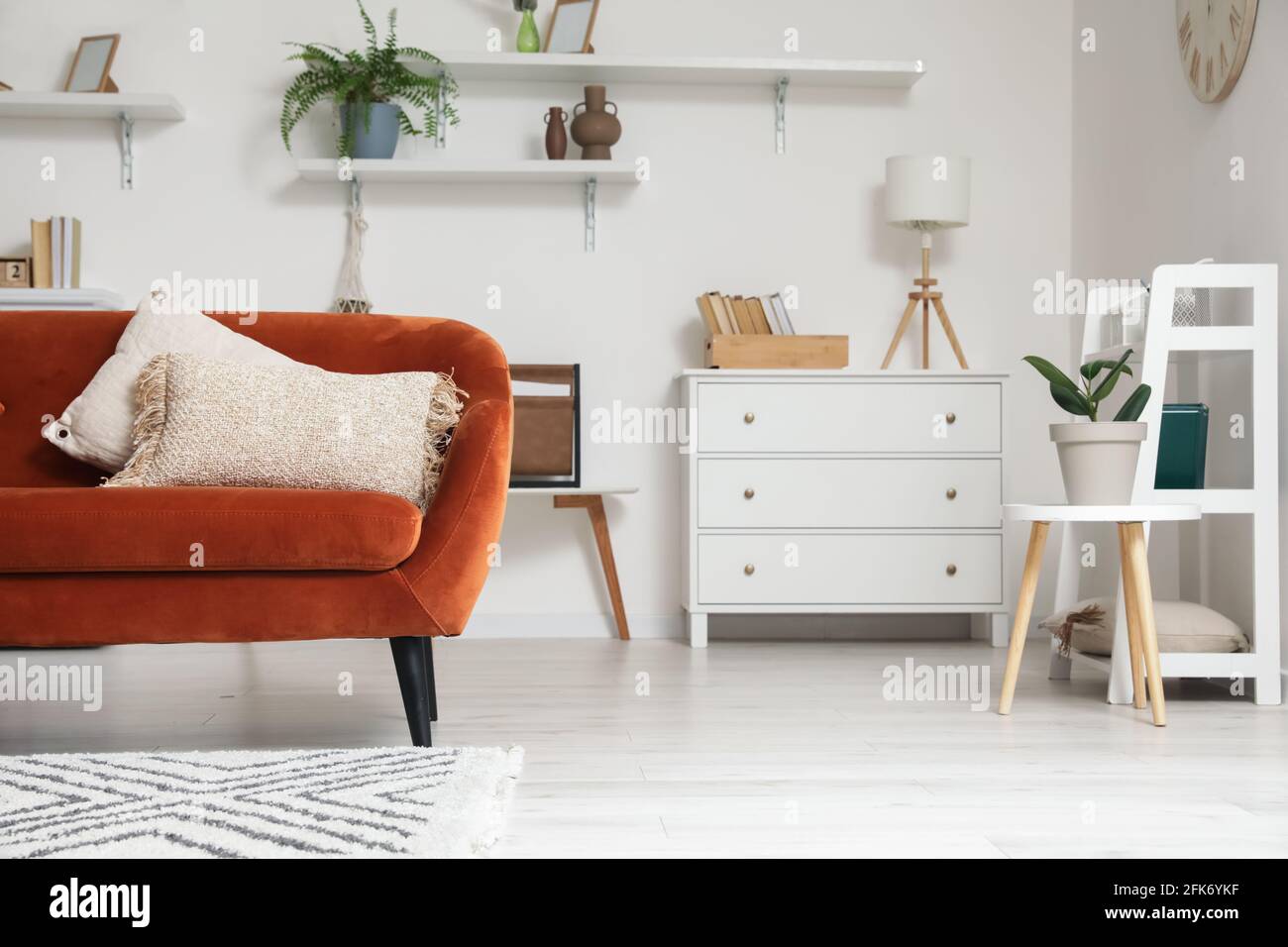 Stylish interior of living room with comfortable sofa Stock Photo - Alamy