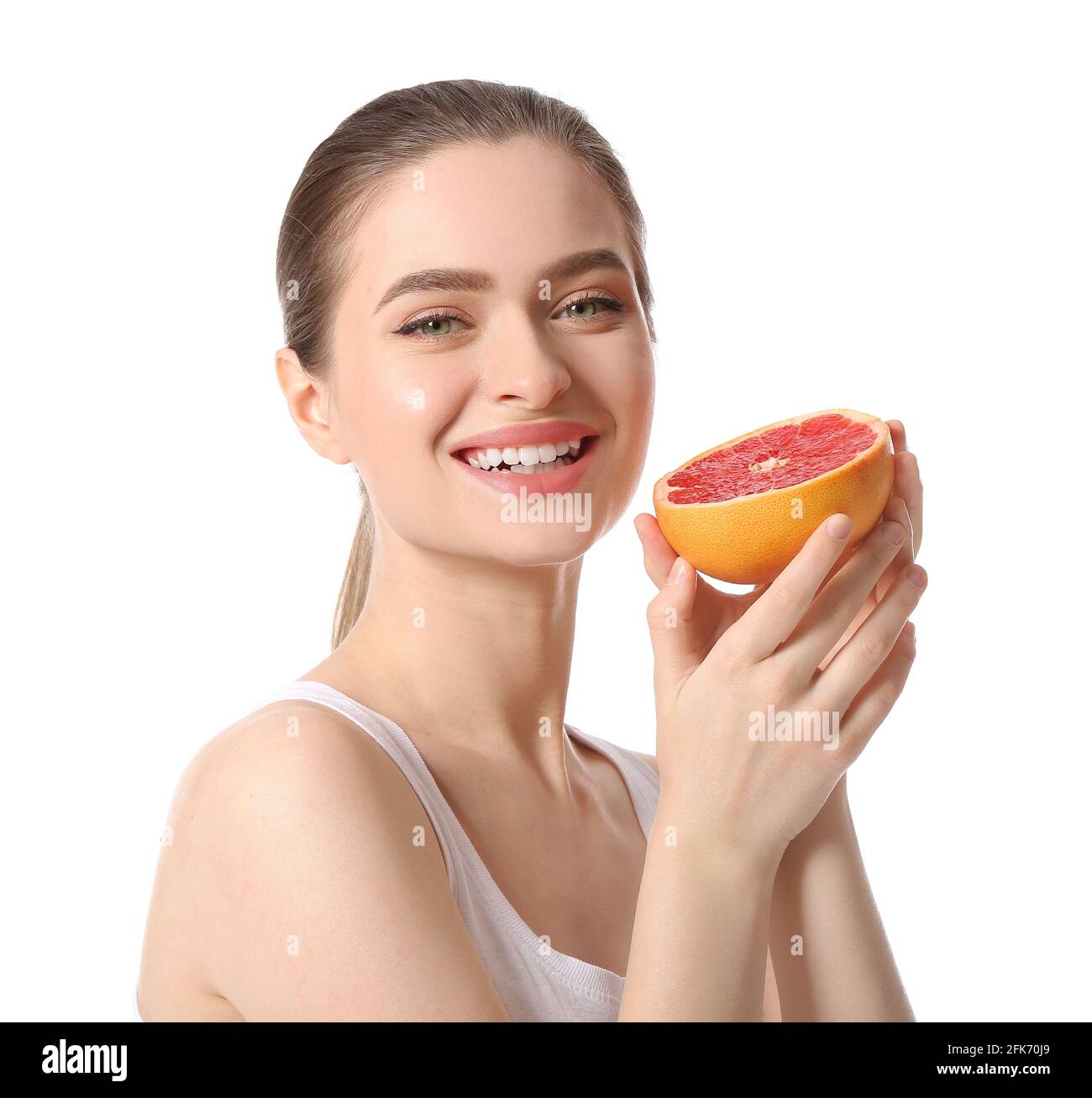 Beautiful young woman with grapefruit on white background Stock Photo ...