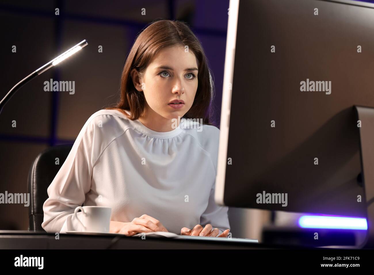 Young woman using computer late at night. Addiction concept Stock Photo ...