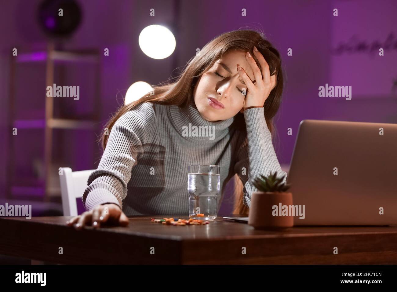 Young woman taking pills at night. Addiction concept Stock Photo - Alamy