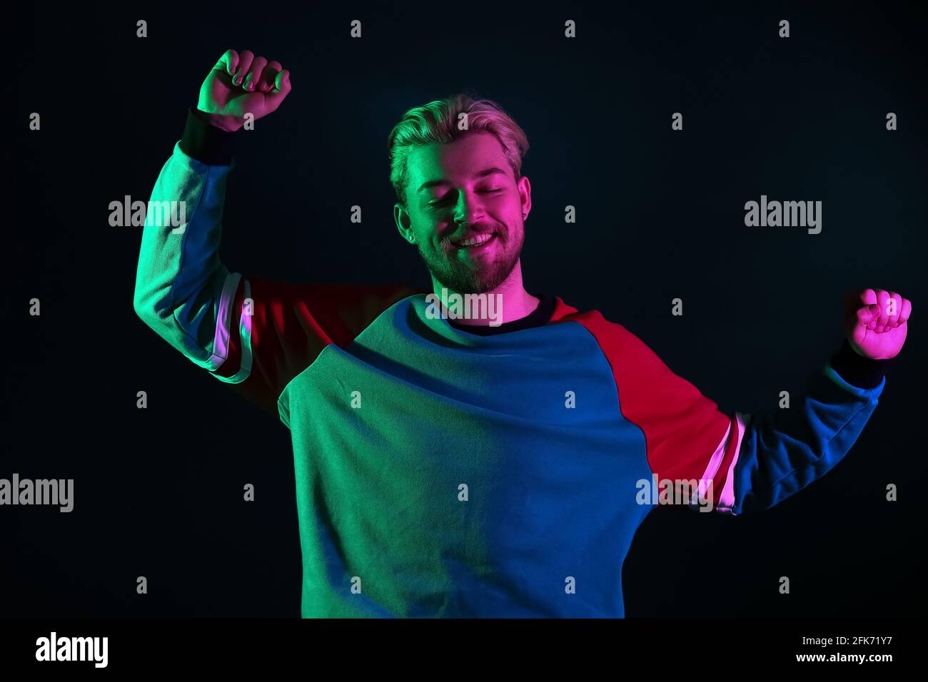 Toned portrait of handsome young man on dark background Stock Photo - Alamy