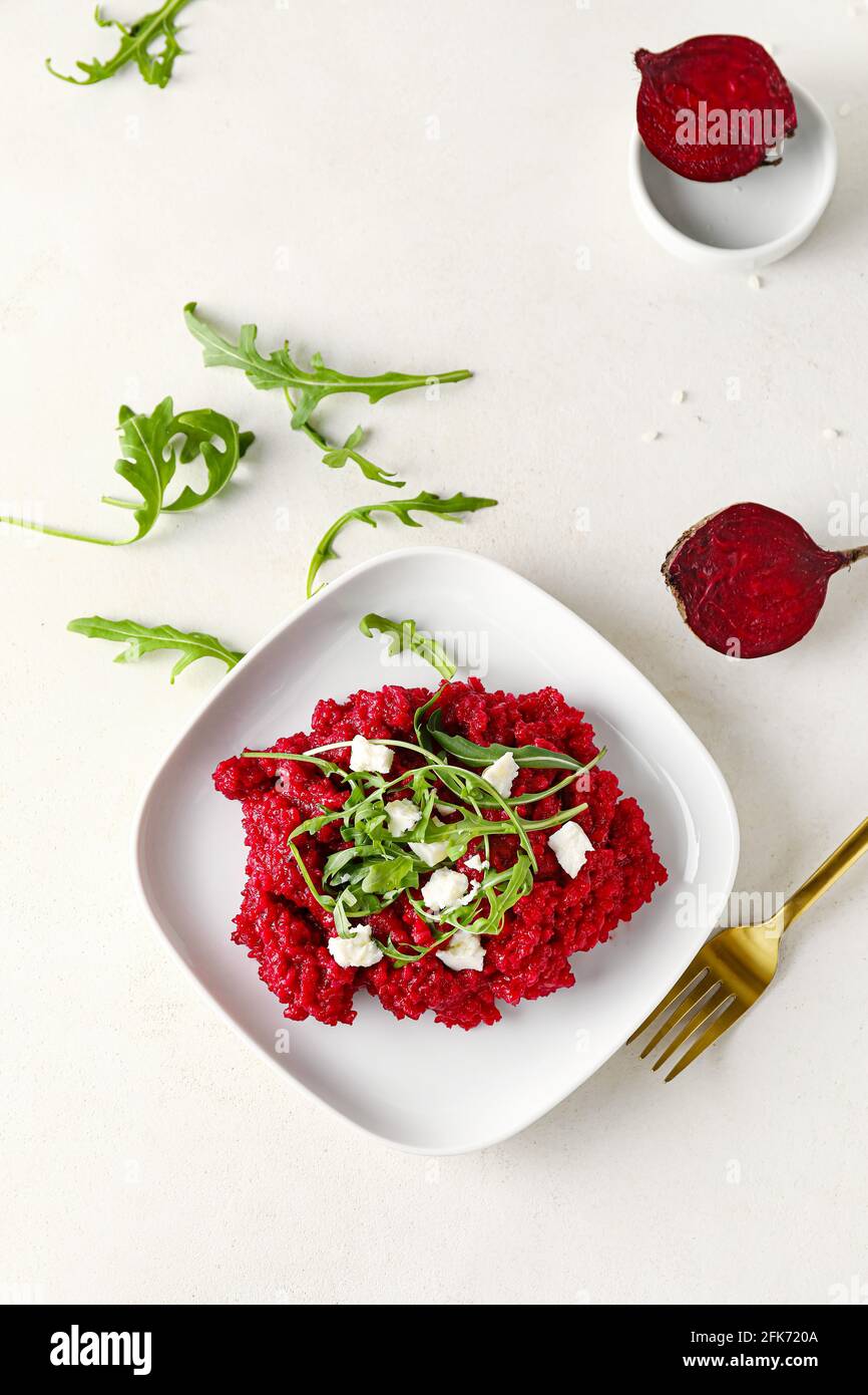 Plate with tasty beet risotto on light background Stock Photo - Alamy