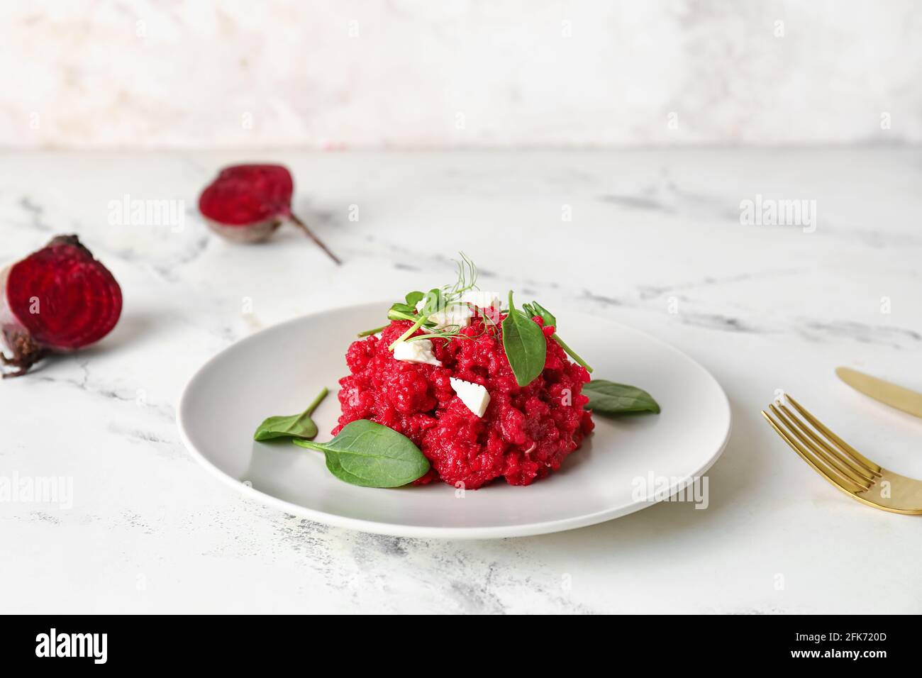 Plate with tasty beet risotto on light background Stock Photo - Alamy
