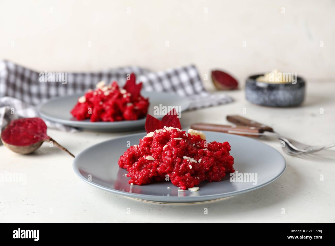 Plates with tasty beet risotto on light background Stock Photo - Alamy