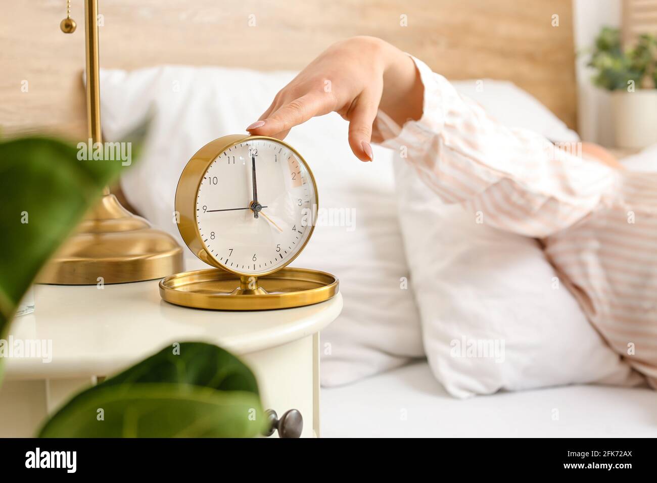 Woman switching off alarm clock hi-res stock photography and images - Alamy