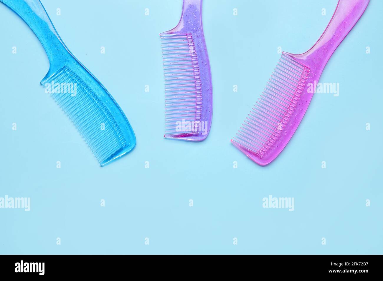 Plastic hair combs on color background Stock Photo - Alamy