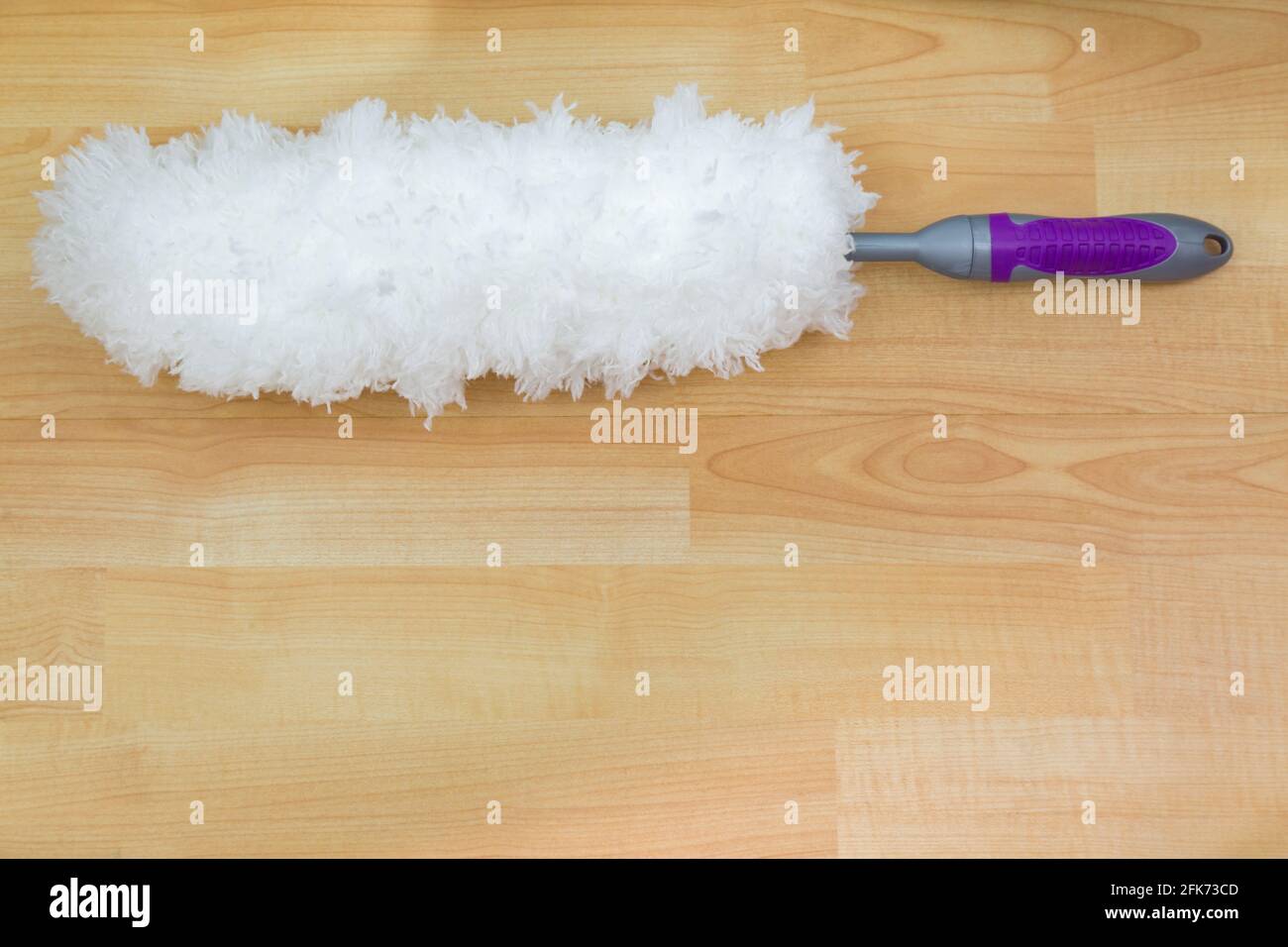 Soft fluffy white furry feather static duster with purple handle on ...